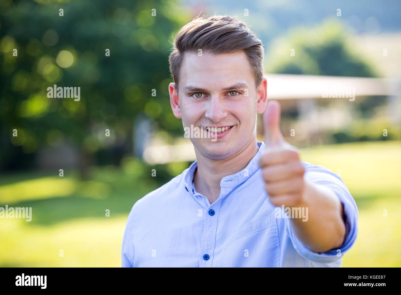 Photo of a confident man smiling for the camera Stock Photo - Alamy