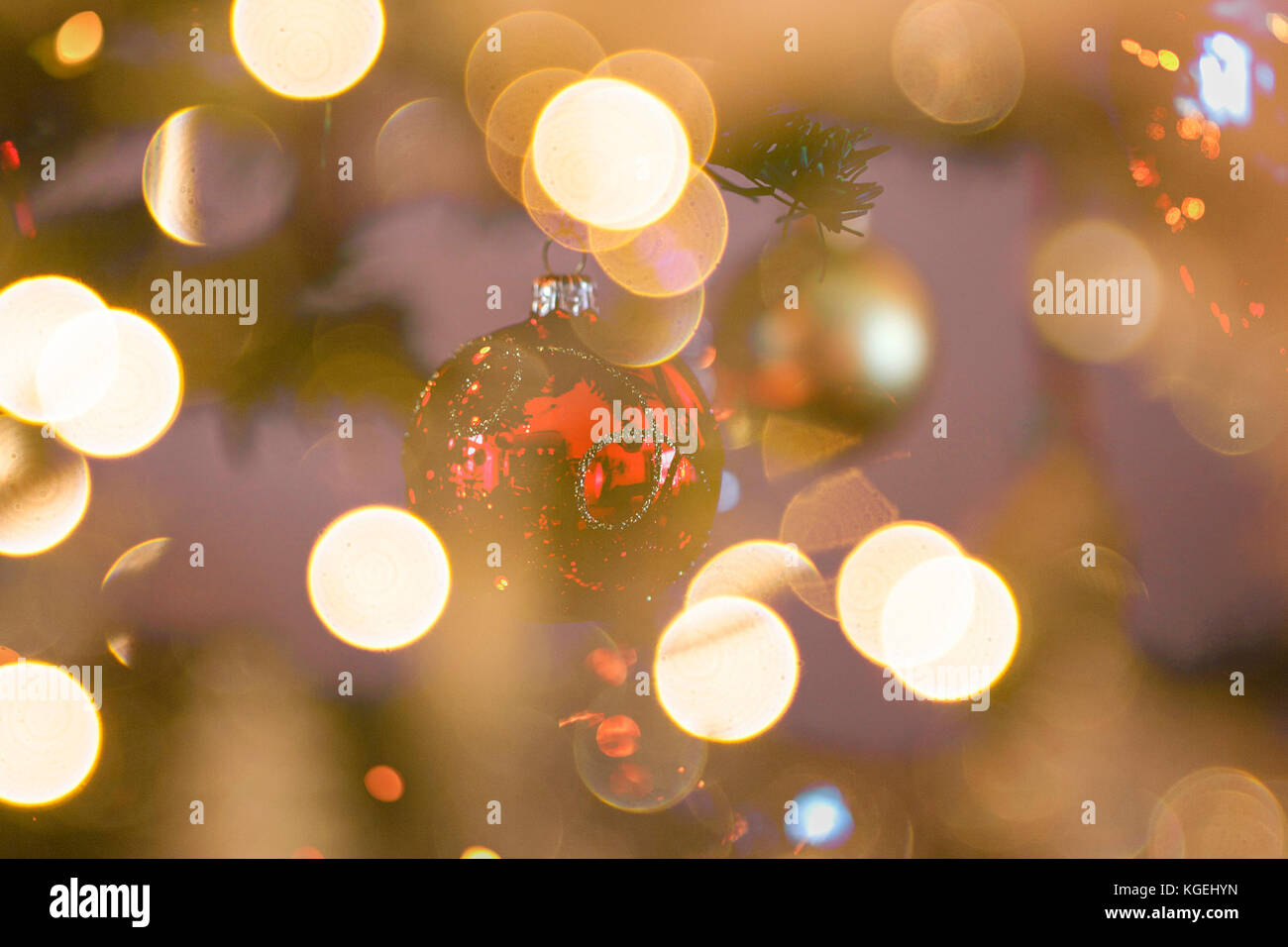Holiday background with bauble, tree and lights Stock Photo - Alamy