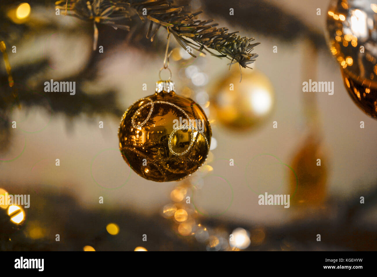 Holiday background with bauble, tree and lights Stock Photo - Alamy