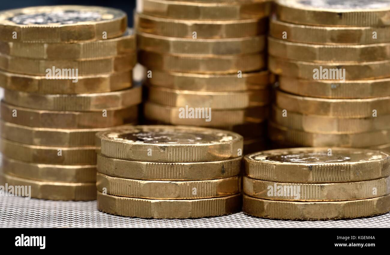 One pound coin coins stack stacks Stock Photo - Alamy