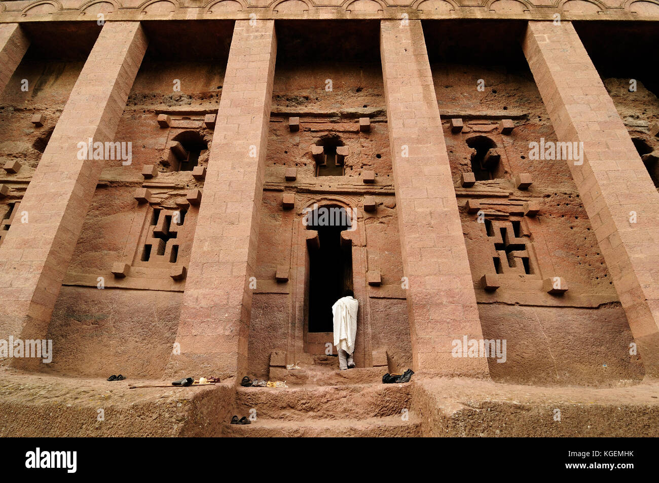 Ethiopian pilgrim is praying in the complex of temples in solid rock in ...