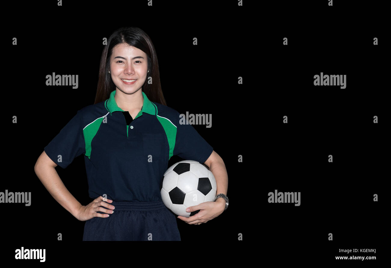 cute athlete girl smile with football isolated on black background ...