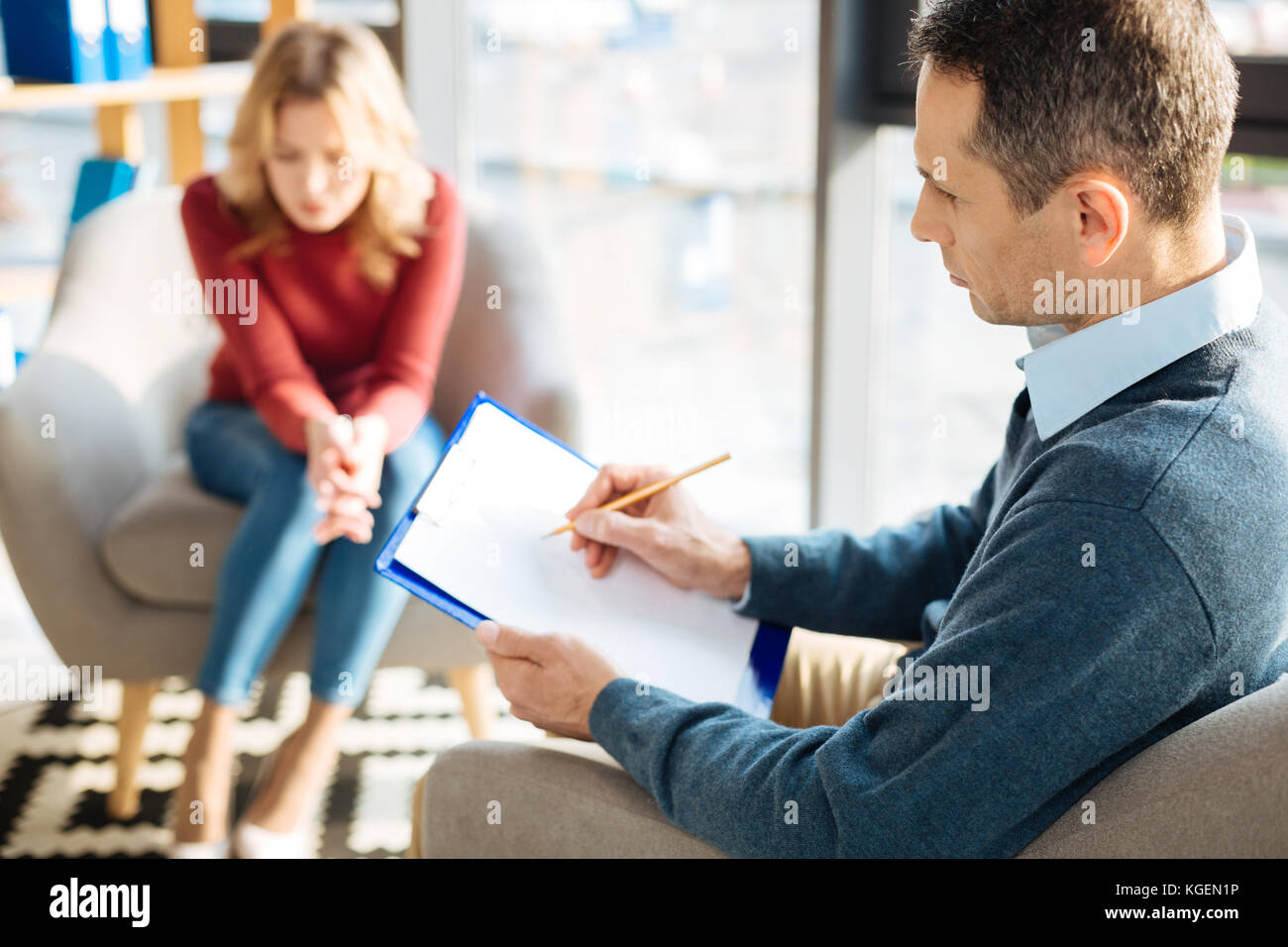 Sad handsome man listening to the patient Stock Photo - Alamy