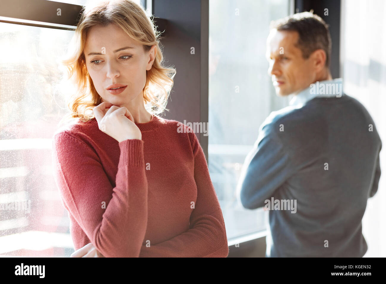 Sad unhappy woman holding her chin Stock Photo - Alamy