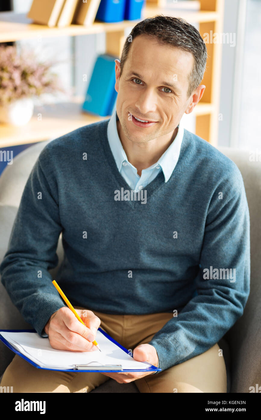 Positive handsome man taking notes Stock Photo - Alamy