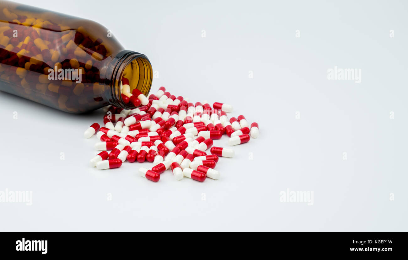 Colorful of antibiotic capsules pills with amber glass bottle on white ...