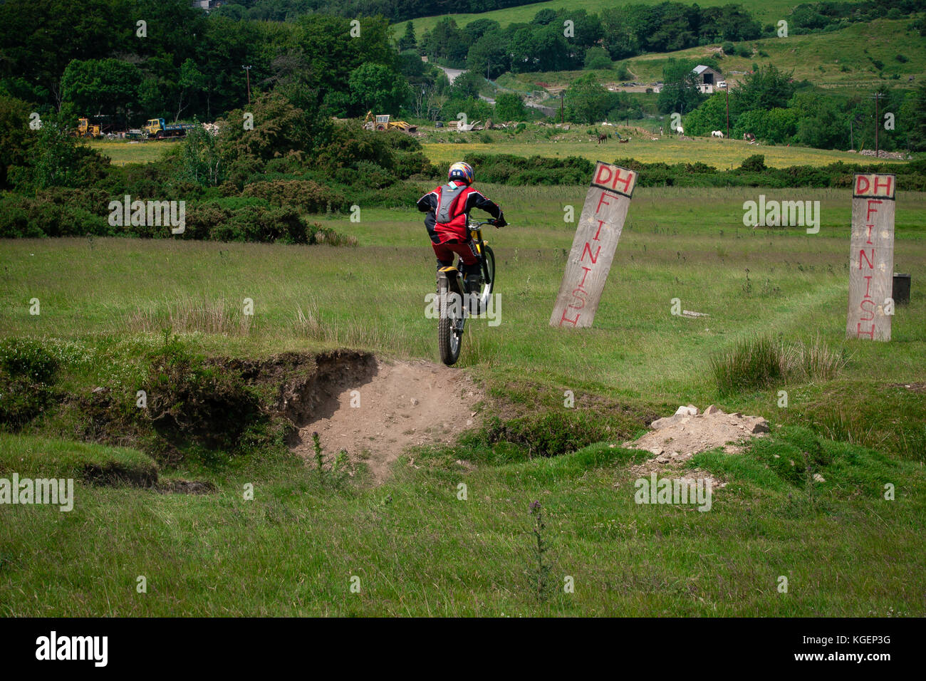 Motorcross bike rider on a finish line of a cross trail showing of ...