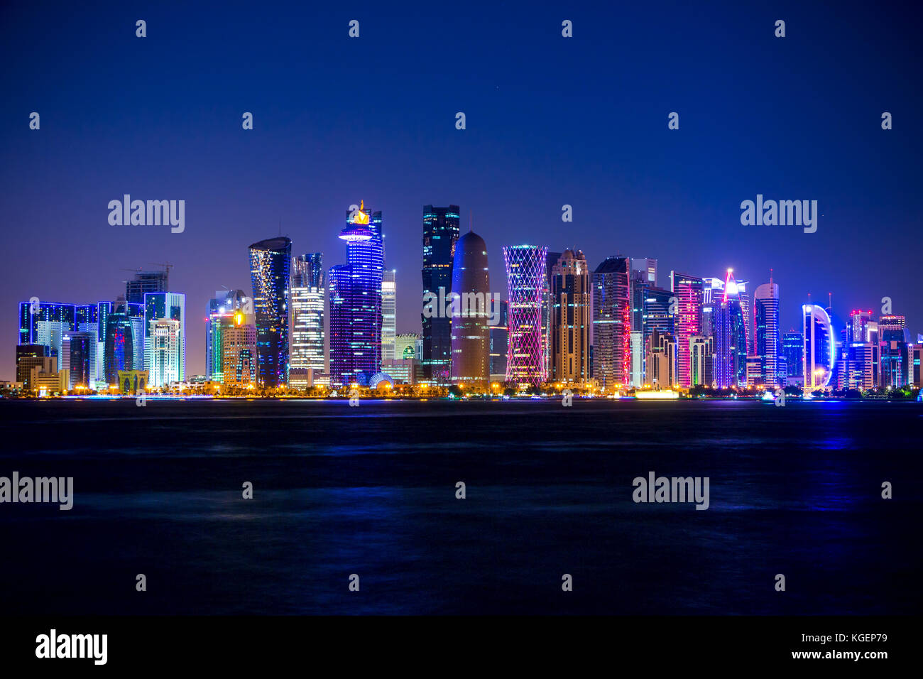 Qatar. Doha skyscrapers with external lighting. Cloudless sky and night ...