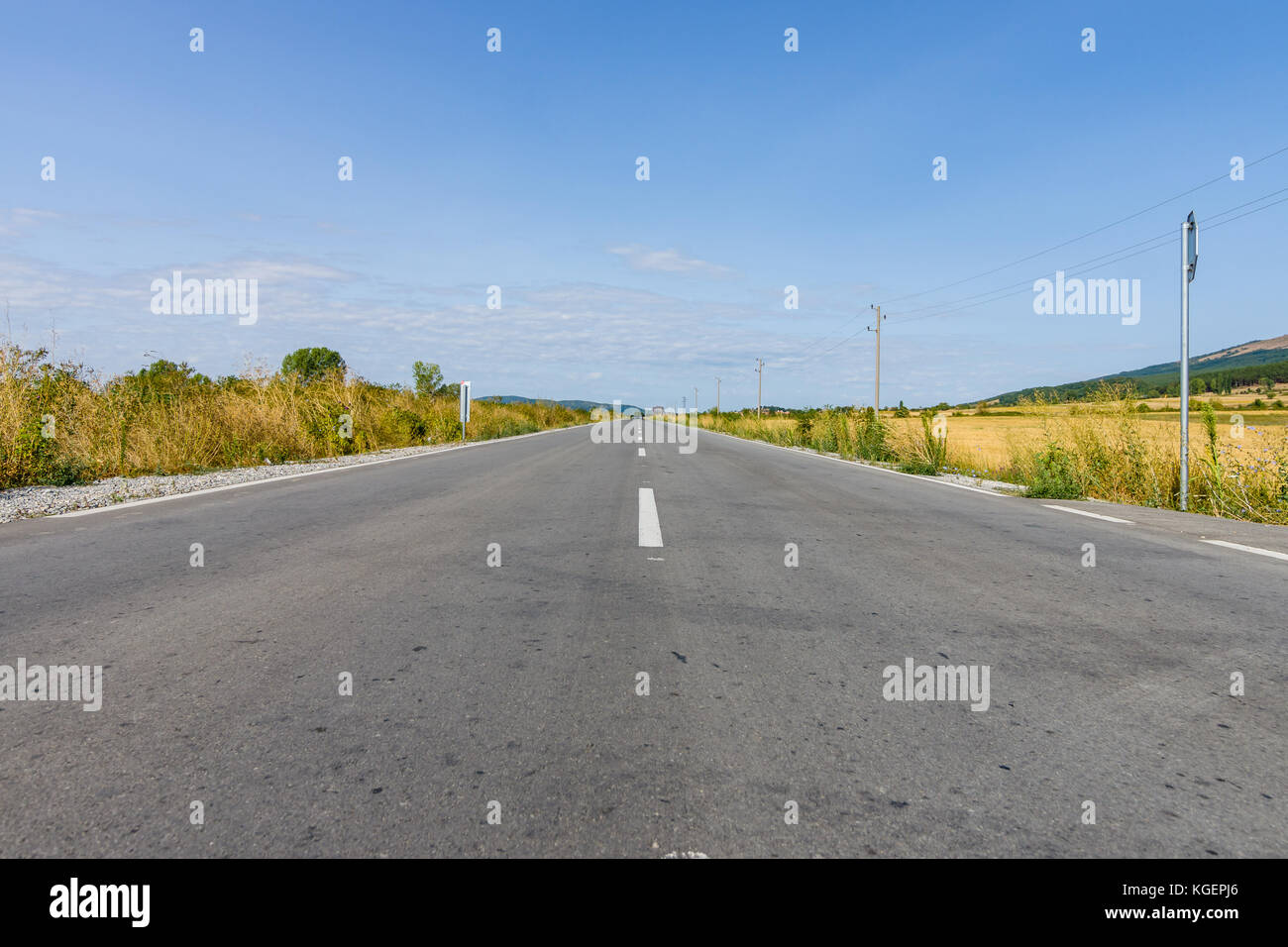 Asphalt road receding into the distance Stock Photo - Alamy