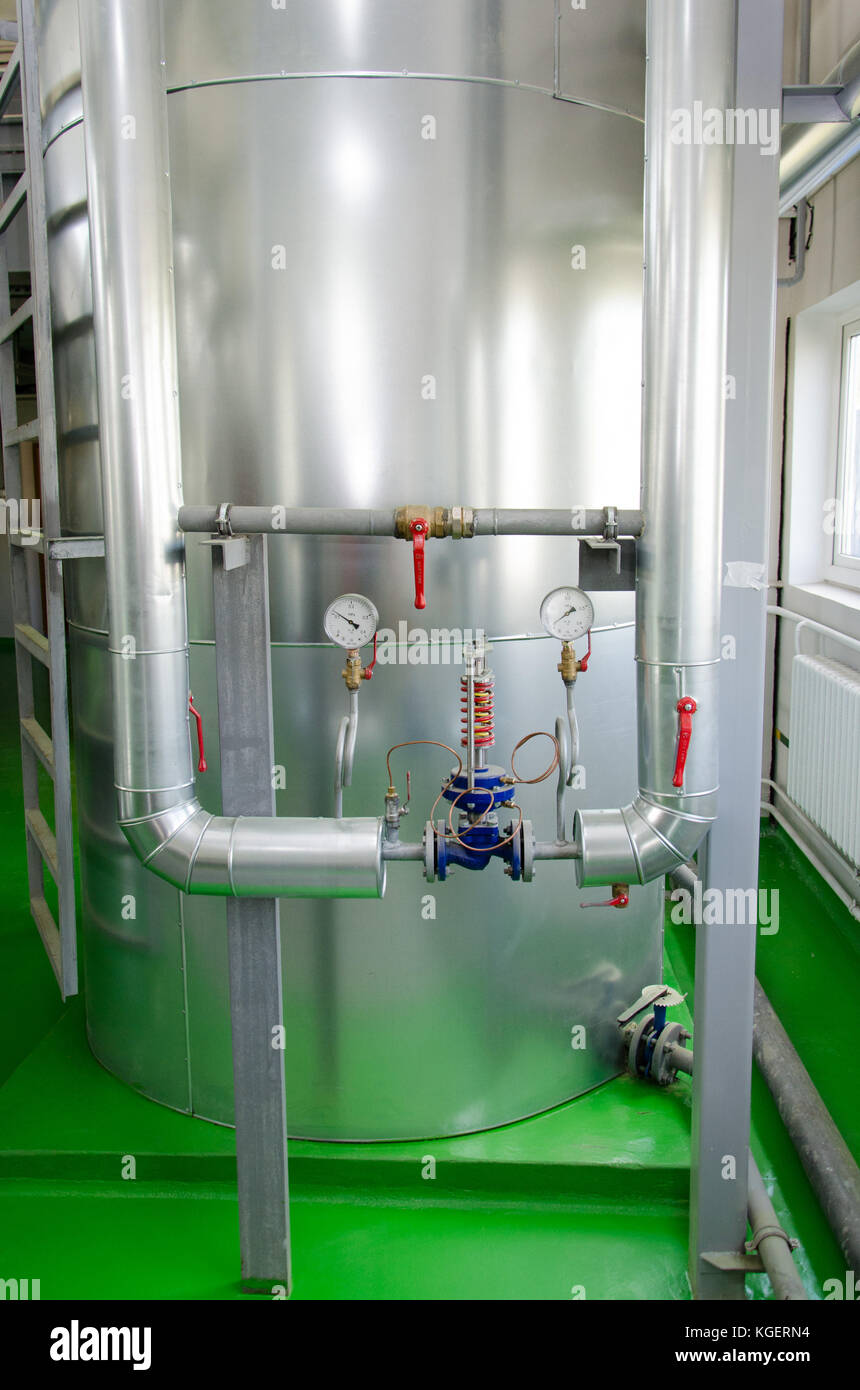 The interior of a modern industrial gas boiler room. Pipelines, water ...