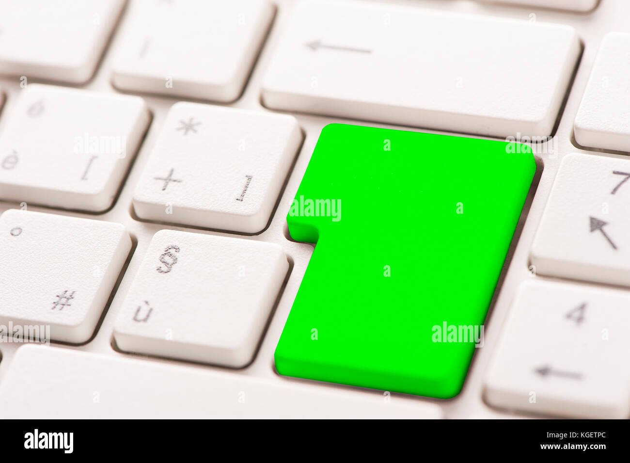 Green button on a white keyboard Stock Photo - Alamy