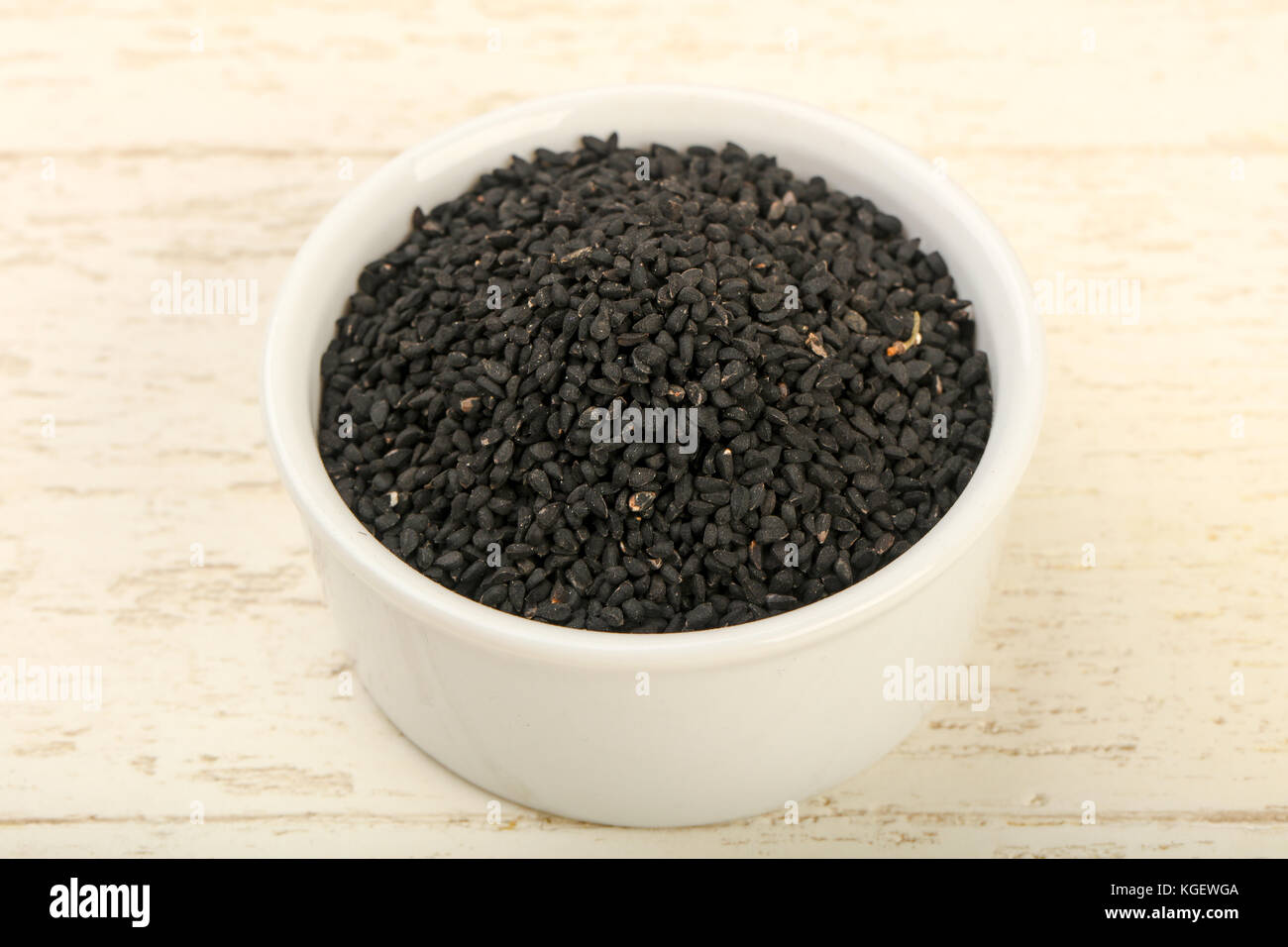 Black nigella seeds heap over wooden background Stock Photo - Alamy