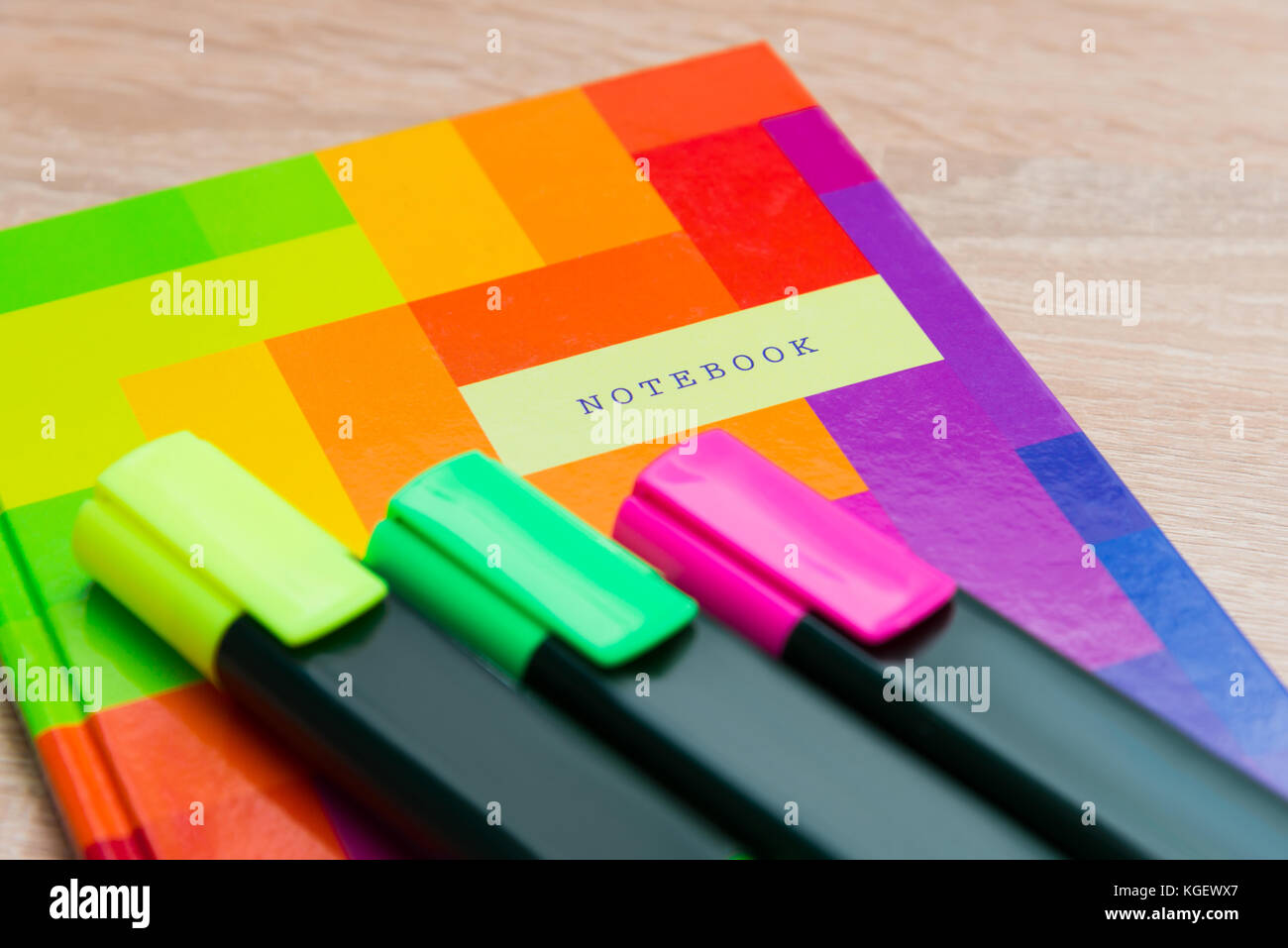 Bright notebook with markers on a wooden background Stock Photo - Alamy