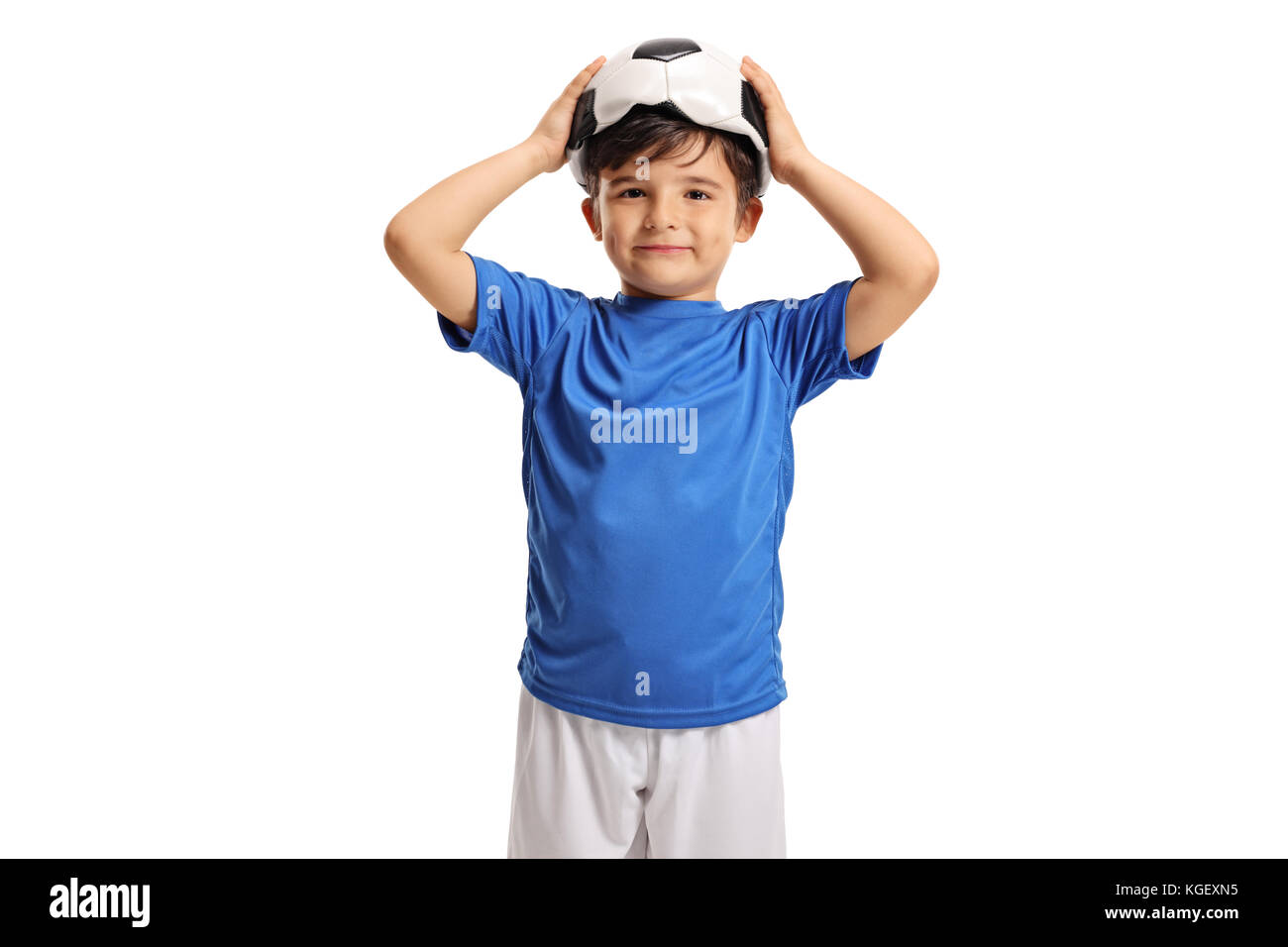 Little footballer holding a deflated football on his head isolated on ...