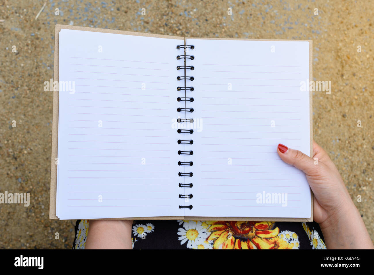 Woman sitting and opening a book Stock Photo - Alamy