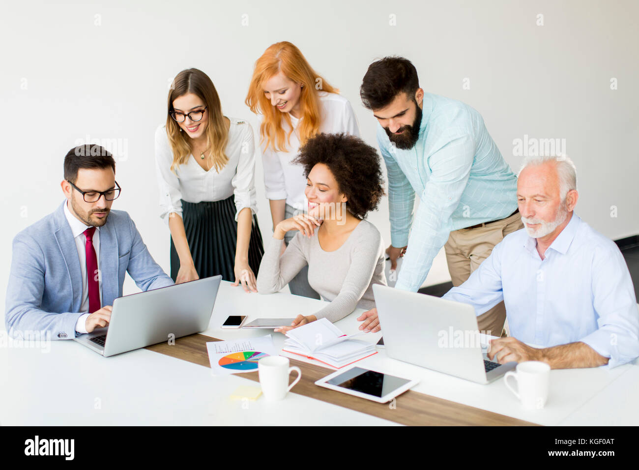 View of multiracial business people around table during staff meeting ...