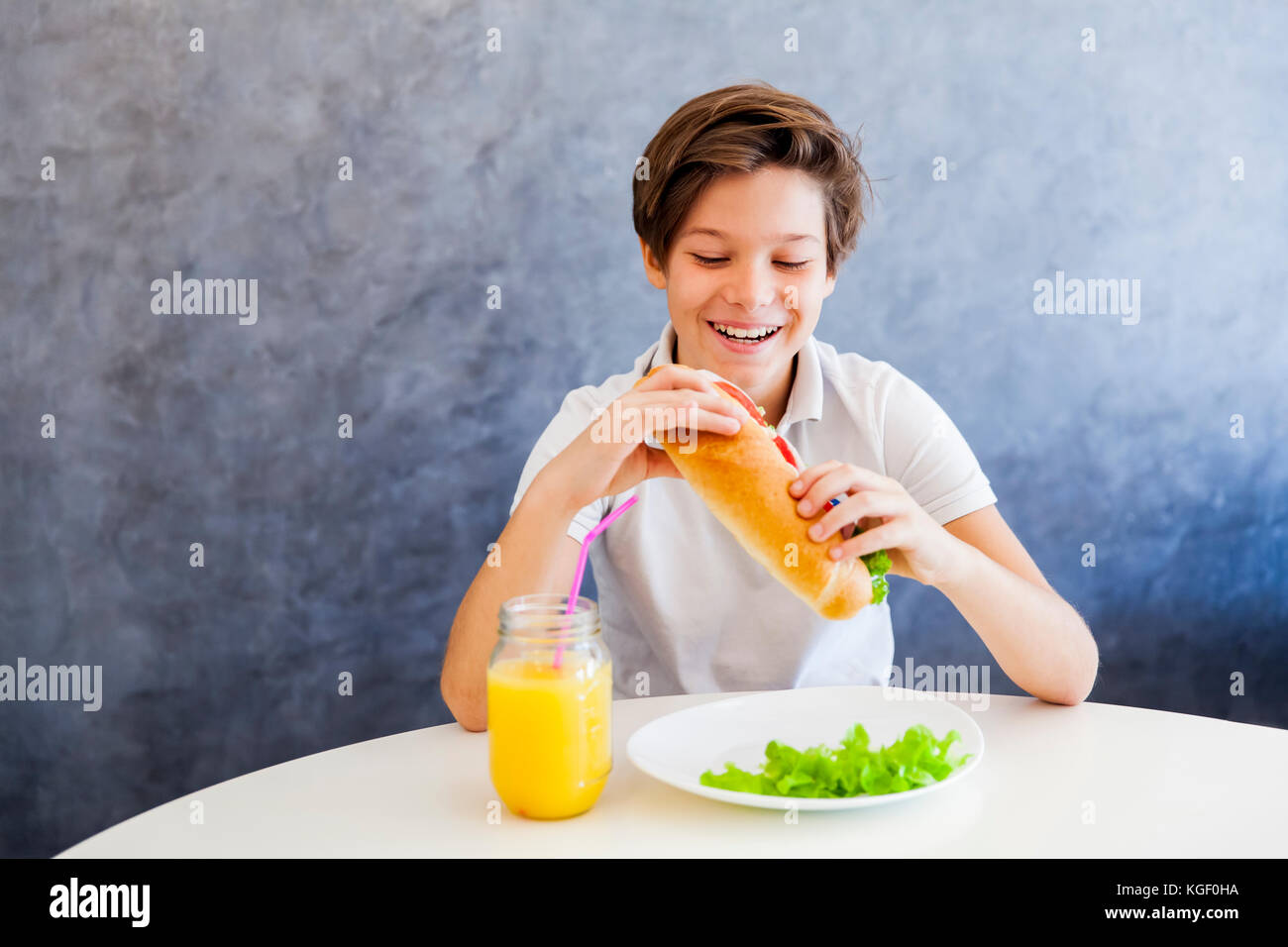 Portrait of teen boy having breakfast Stock Photo - Alamy