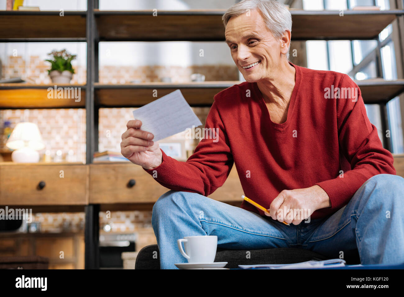 Cheerful happy man looking at the note Stock Photo - Alamy