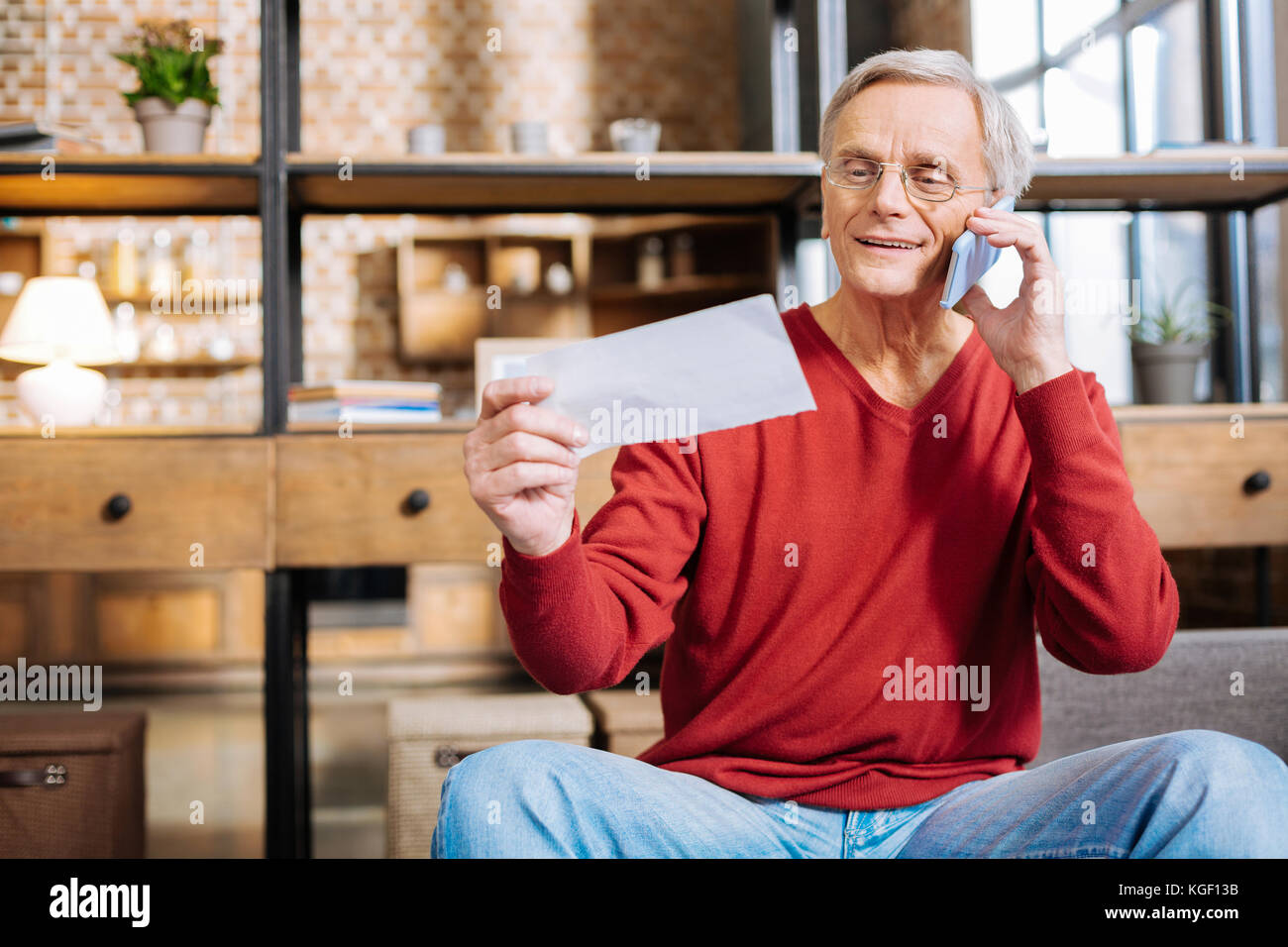 Positive nice man talking on the phone Stock Photo - Alamy