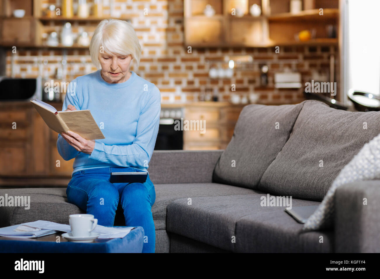 Serious smart woman taking notes Stock Photo - Alamy