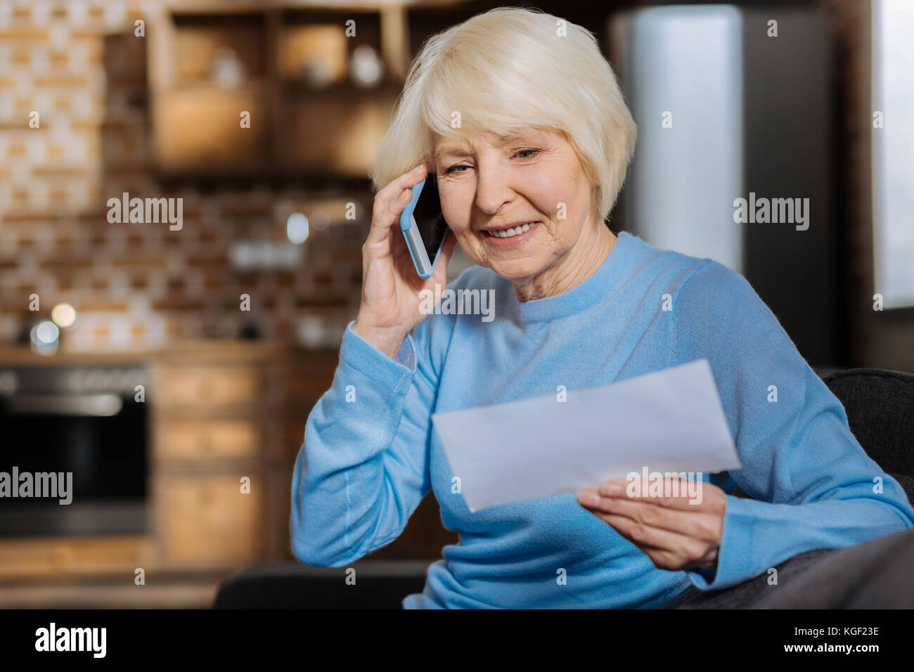 Delighted elderly woman making a phone call Stock Photo - Alamy