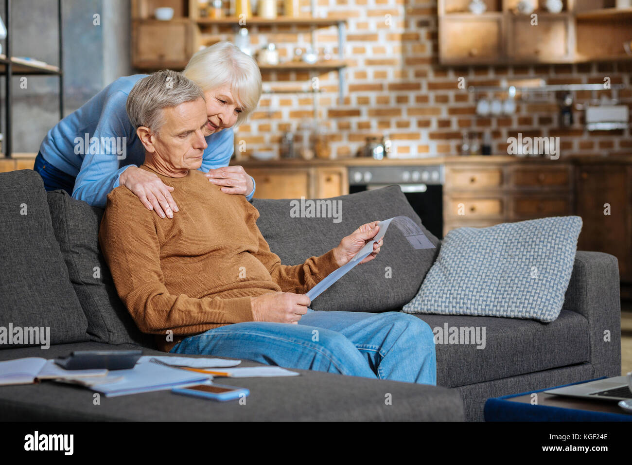 Nice caring woman standing behind his husband Stock Photo - Alamy