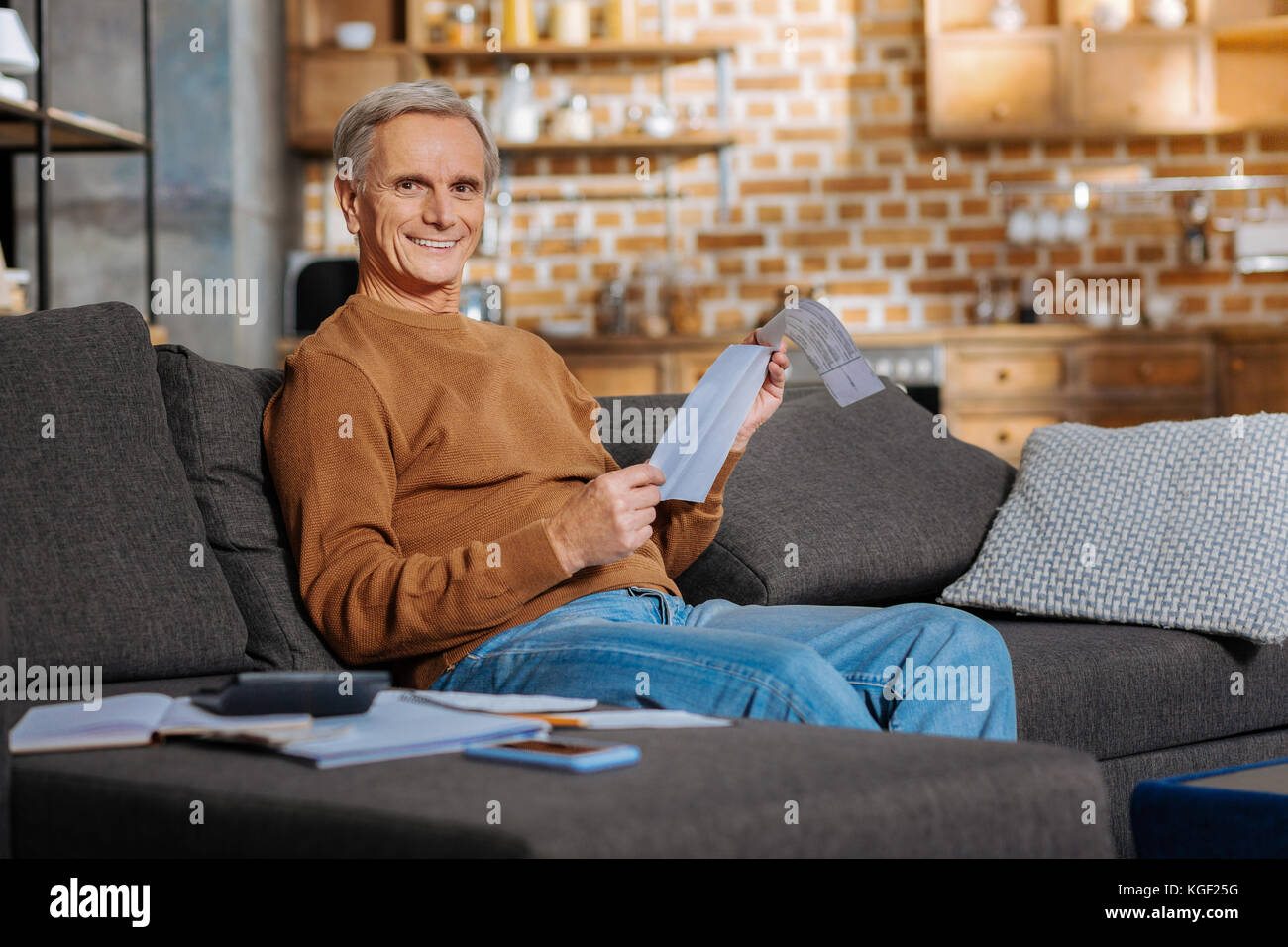 Cheerful happy man reading a document Stock Photo - Alamy