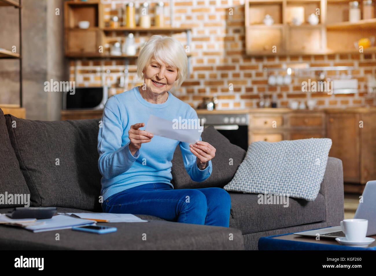 Joyful nice woman reading a note Stock Photo - Alamy