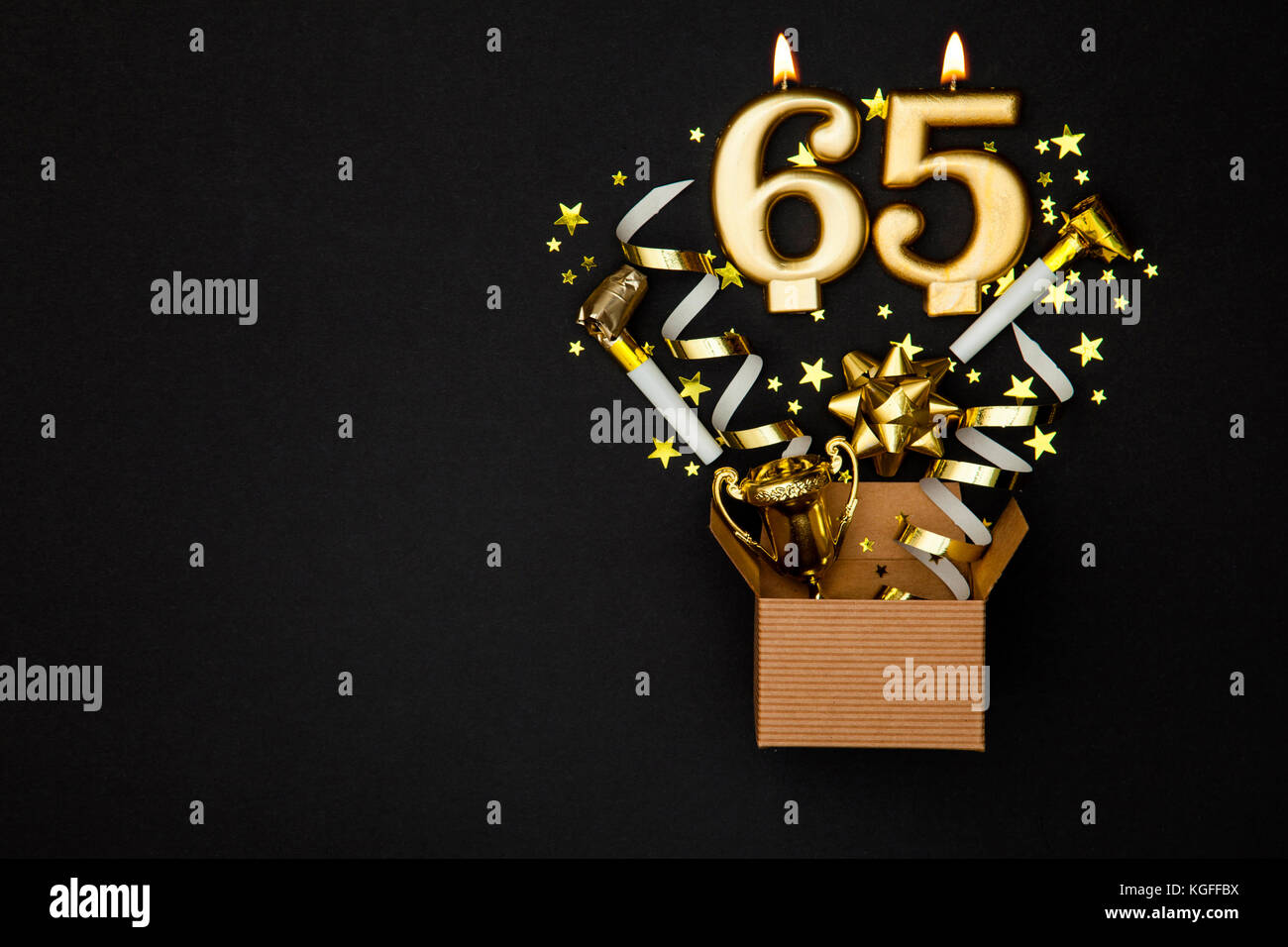 Number 65 gold celebration candle and gift box background Stock Photo ...