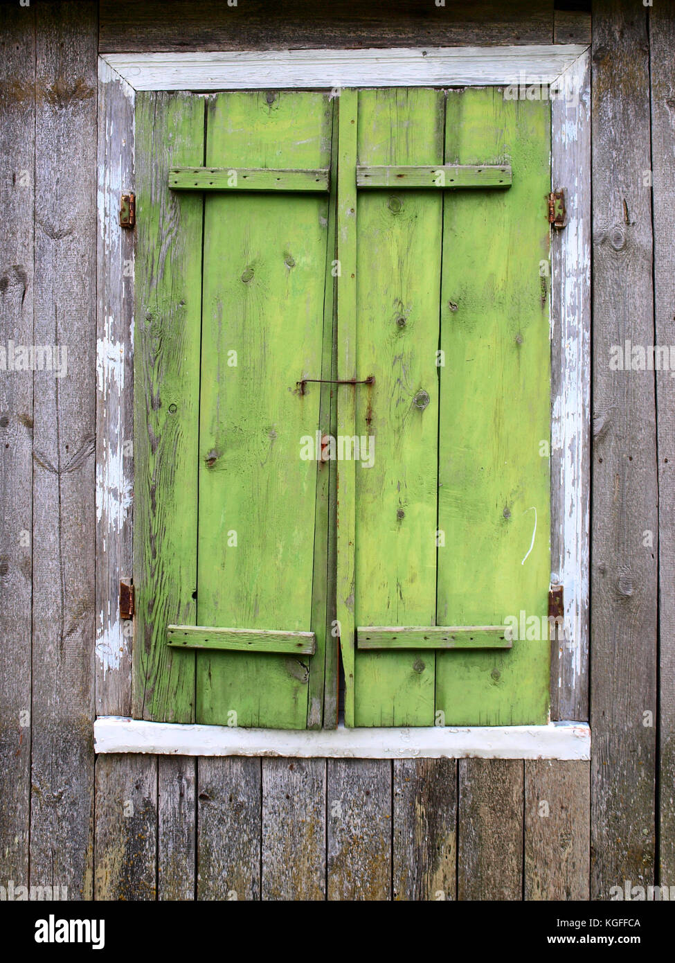 Old wooden house window closed with green colored shutters Stock Photo ...