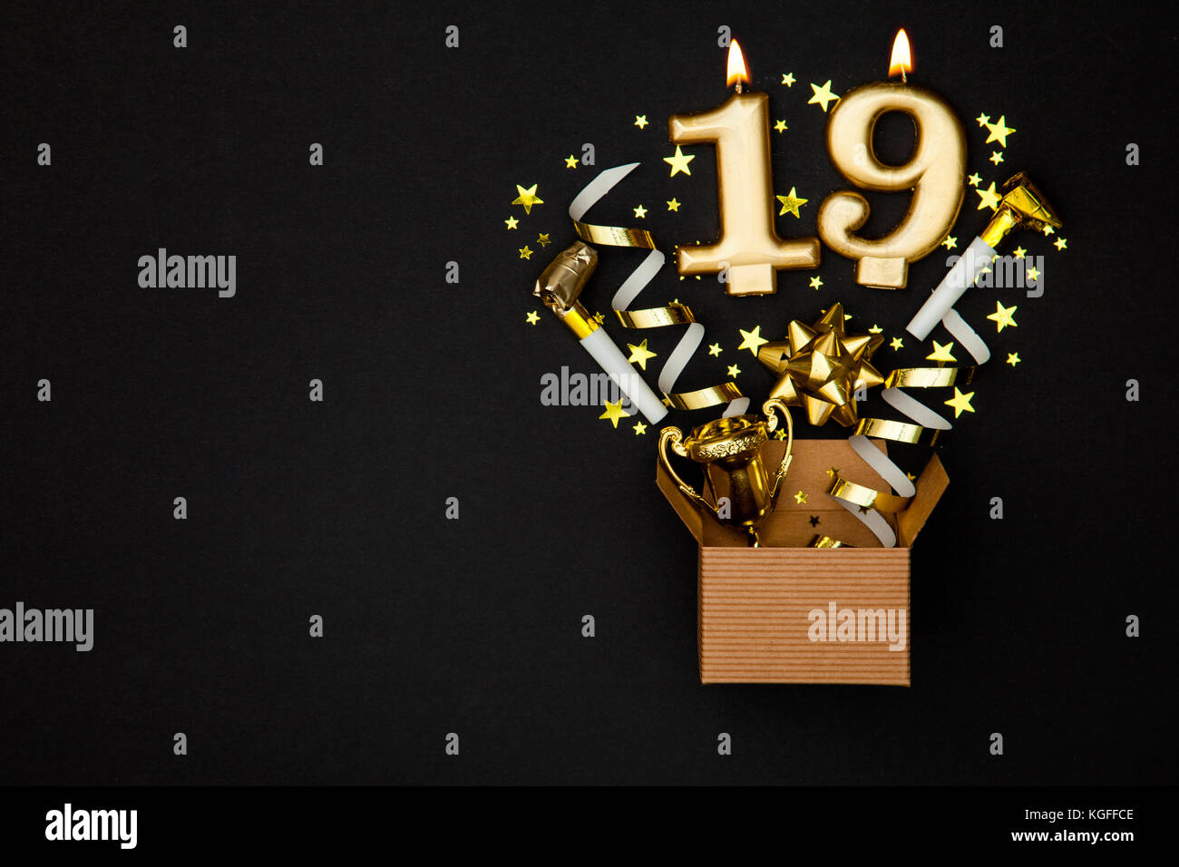 Number 19 gold celebration candle and gift box background Stock Photo ...