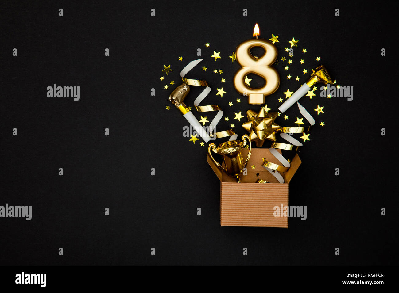 Number 8 gold celebration candle and gift box background Stock Photo ...