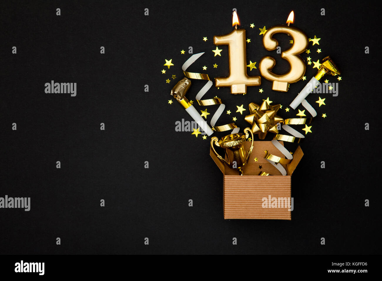 Number 13 gold celebration candle and gift box background Stock Photo ...