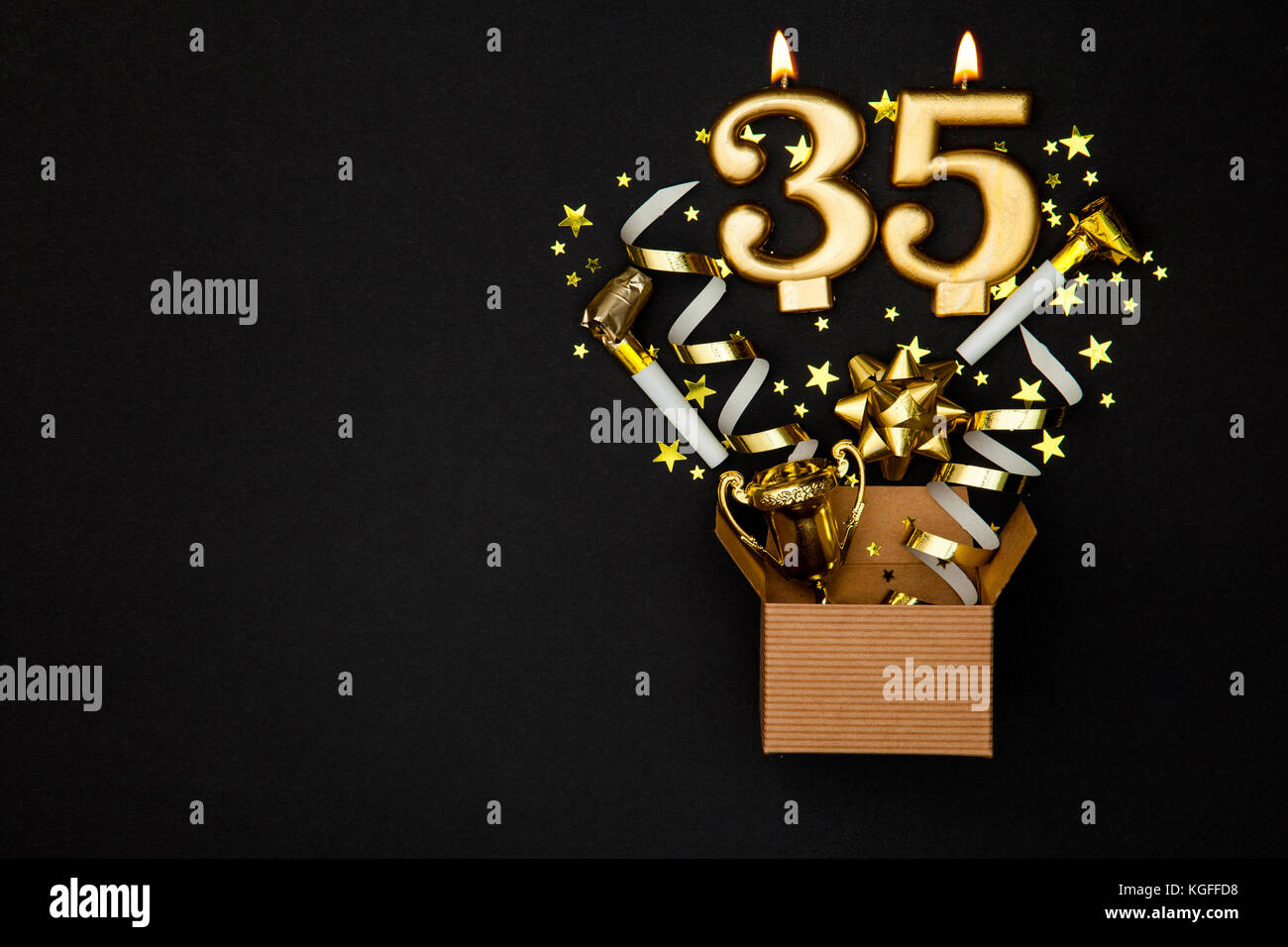 Number 35 gold celebration candle and gift box background Stock Photo ...