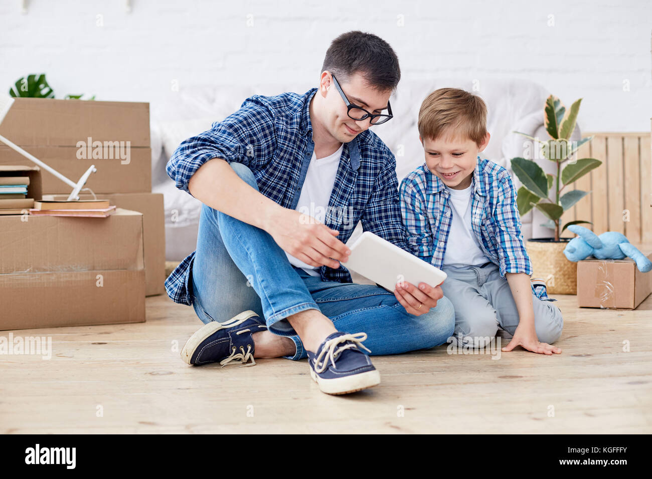 Taking short break from packing stuff: handsome young father and his ...