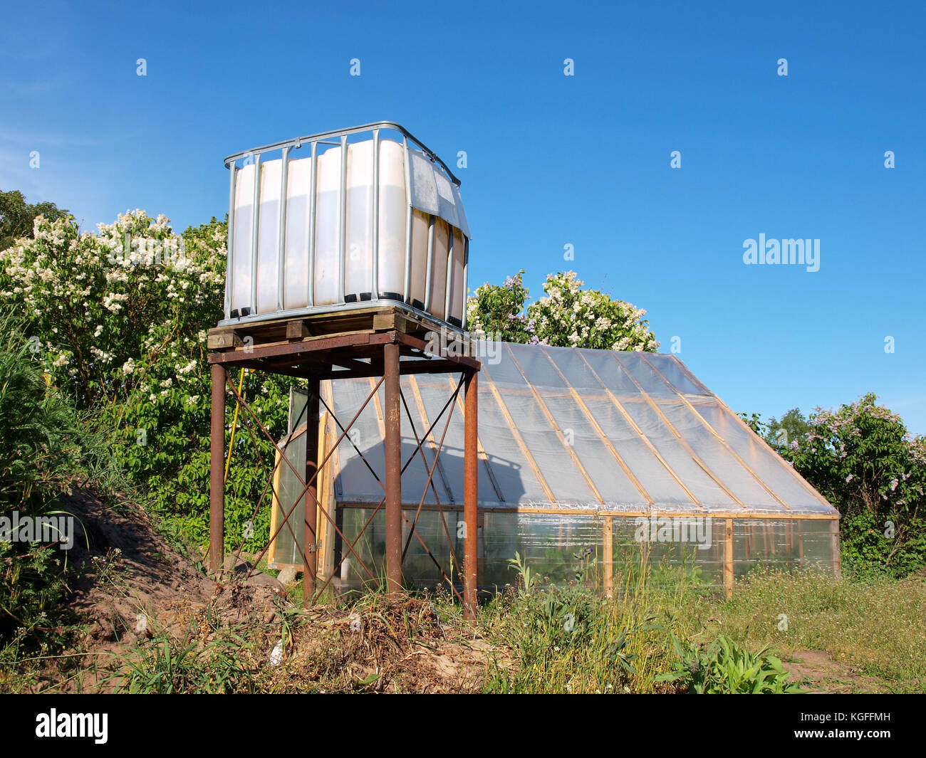 Homemade water tower from plastic container on metal stands for ...