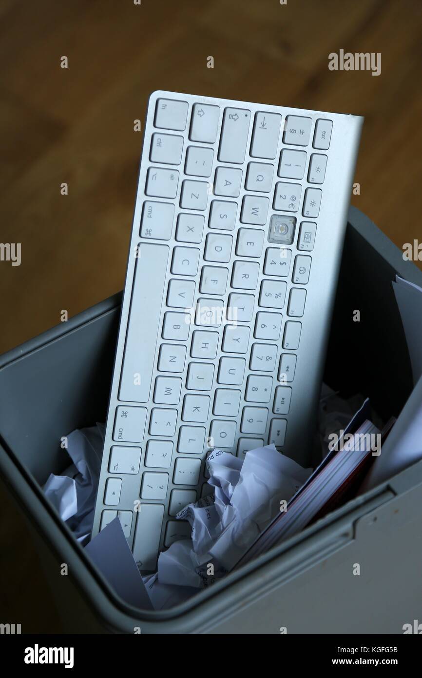 A broken bluetooth Apple Computer Keyboard in a bin Stock Photo - Alamy