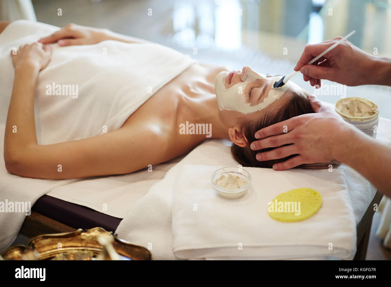 Side view portrait of beautiful young woman in SPA, lying on massage ...