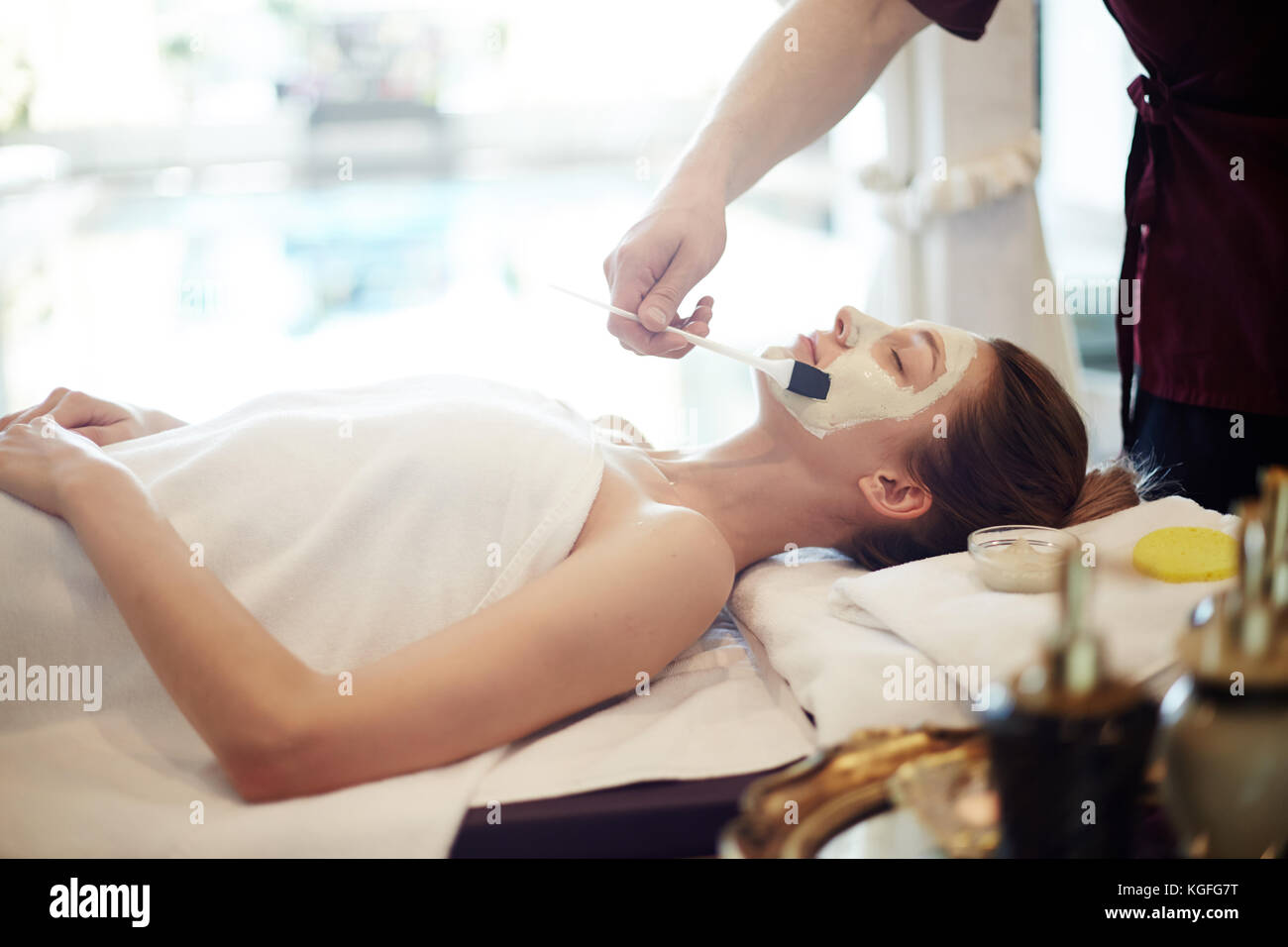 Side view portrait of beautiful young woman in SPA, lying on massage ...
