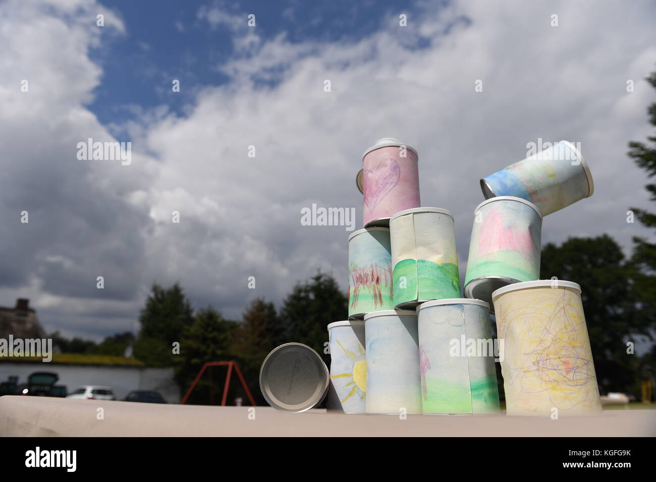 kids throwing a ball at cans Stock Photo - Alamy