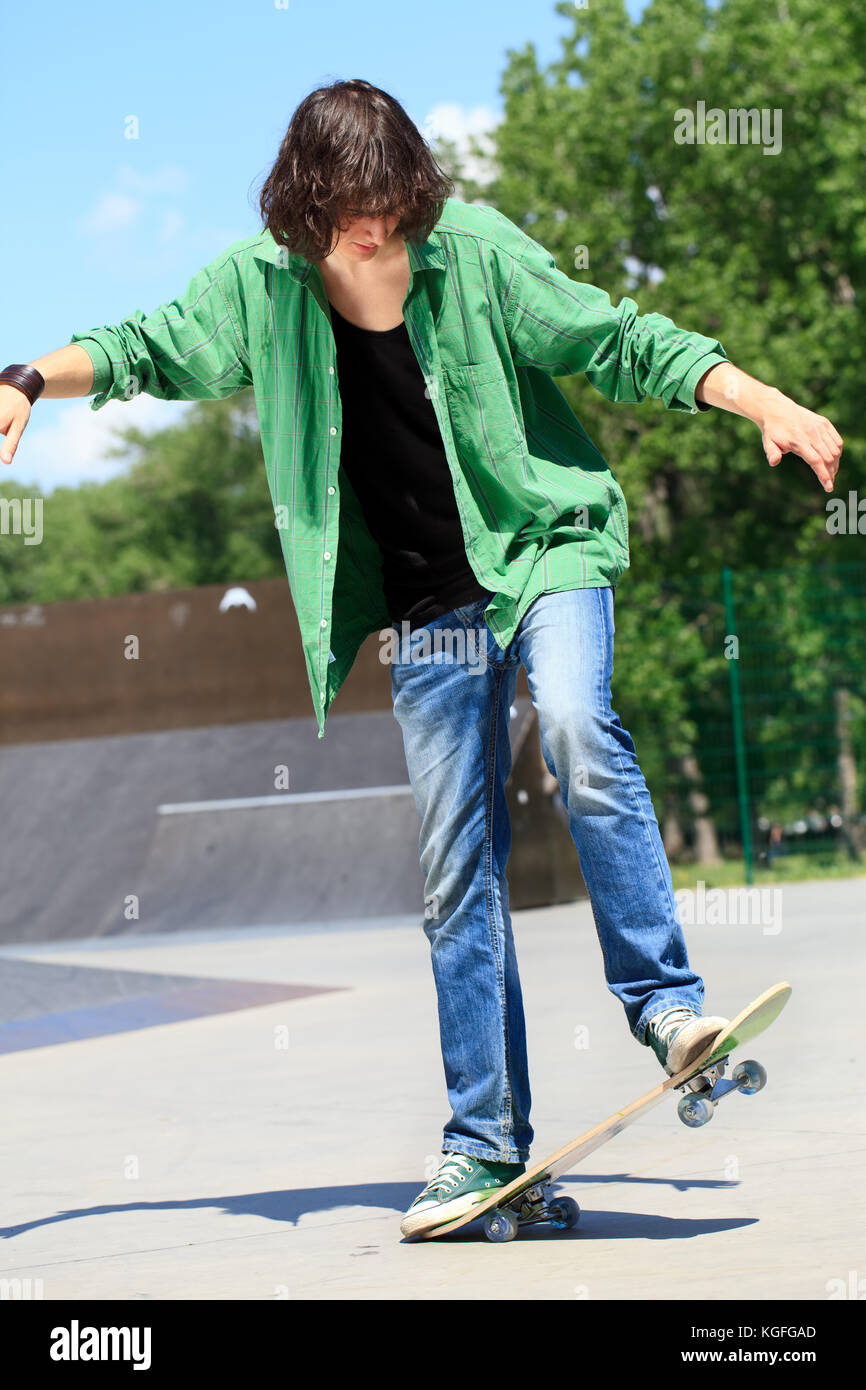 Young man doing stunts on skateboard Stock Photo - Alamy