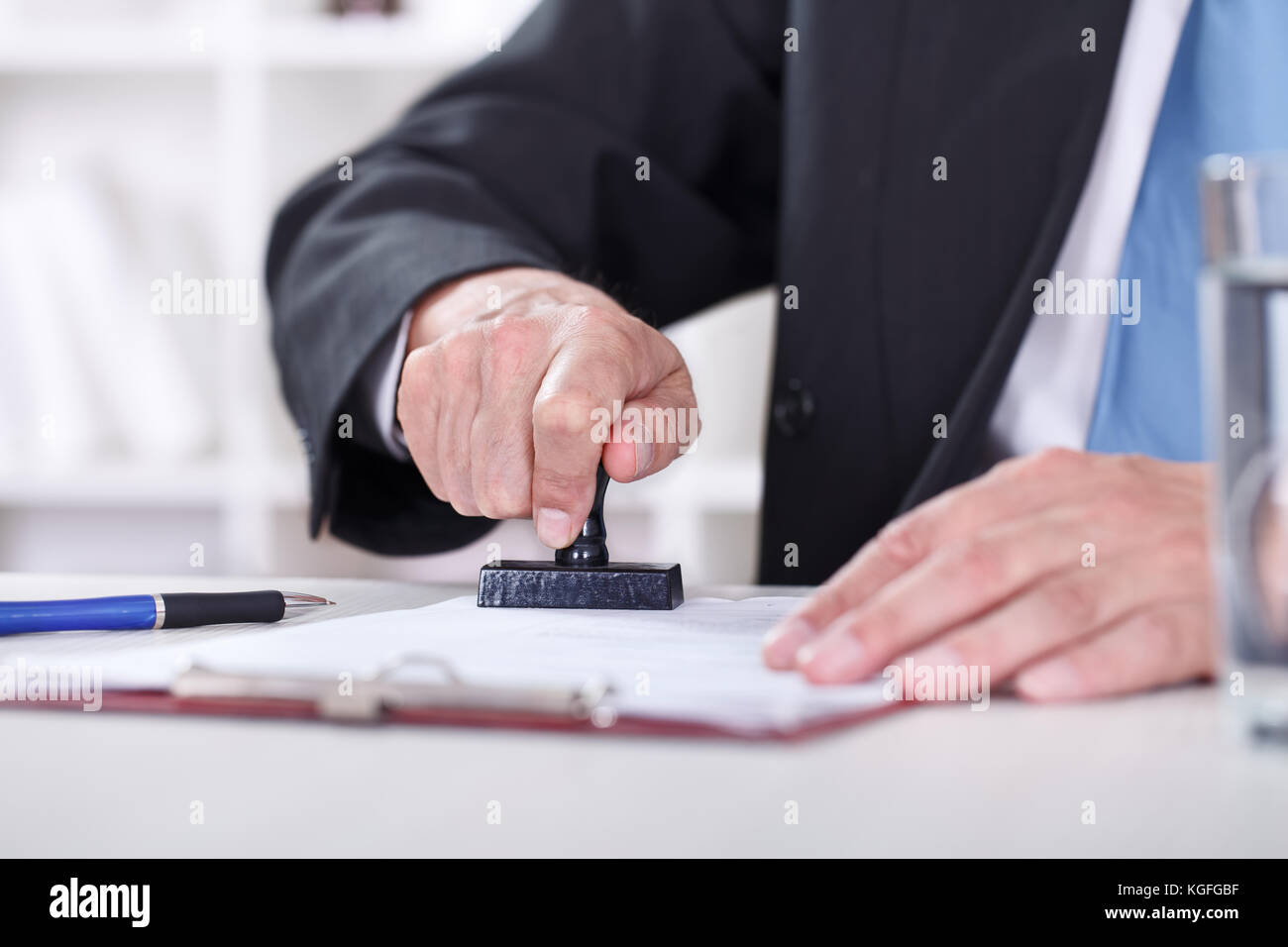 Man’s hand stamping documents, close-up Stock Photo - Alamy