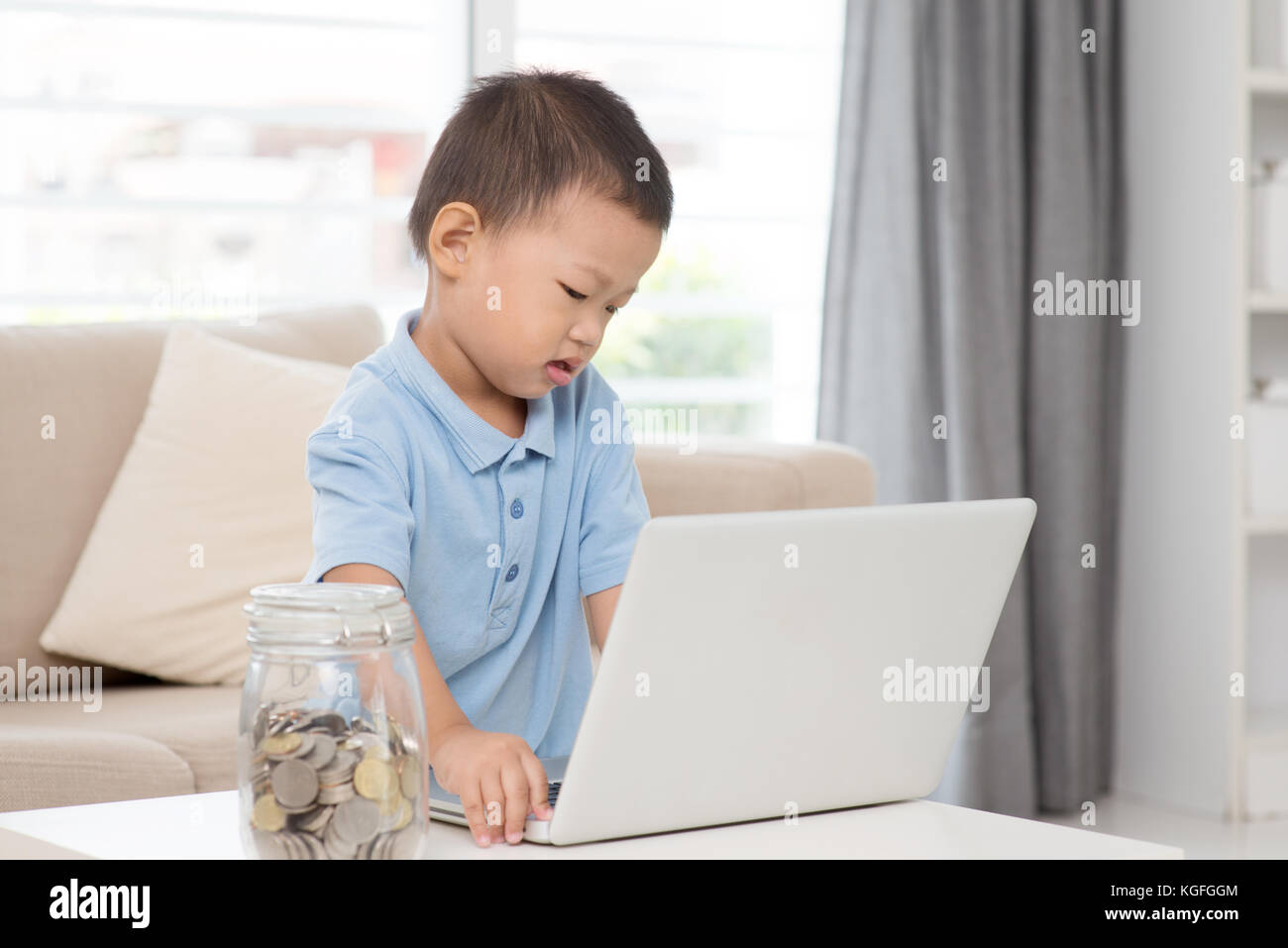 Asian preschool boy using computer laptop at home. Child education and ...