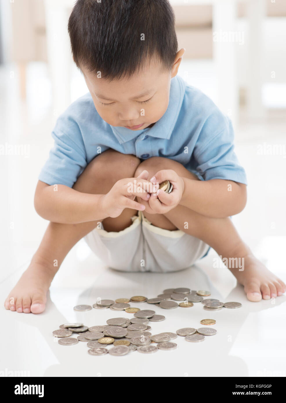 Boy counting coins hi-res stock photography and images - Alamy