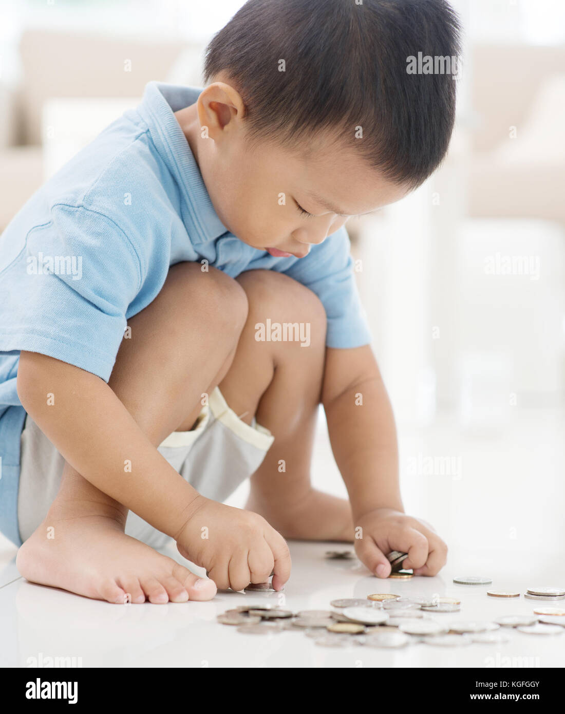 Boy counting coins hi-res stock photography and images - Alamy