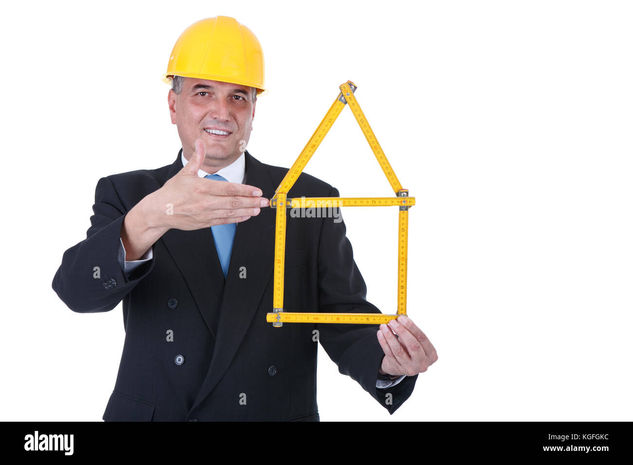 smiling, male architect holding folding ruler with house shape ...