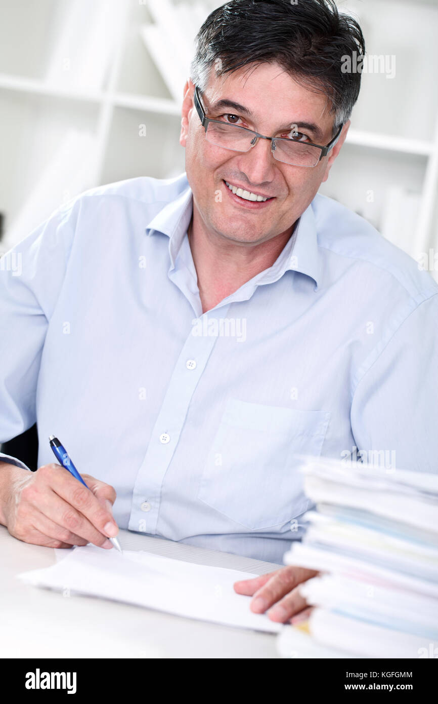 Smiling senior professor review tests in his office Stock Photo - Alamy