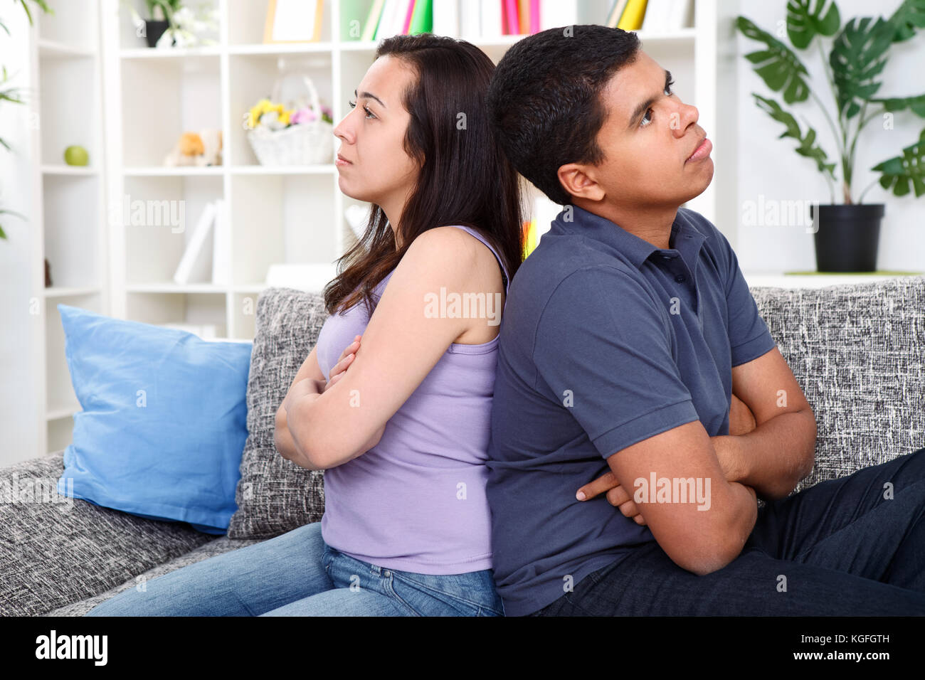 angry couple after conflict, sitting on couch back to back Stock Photo ...