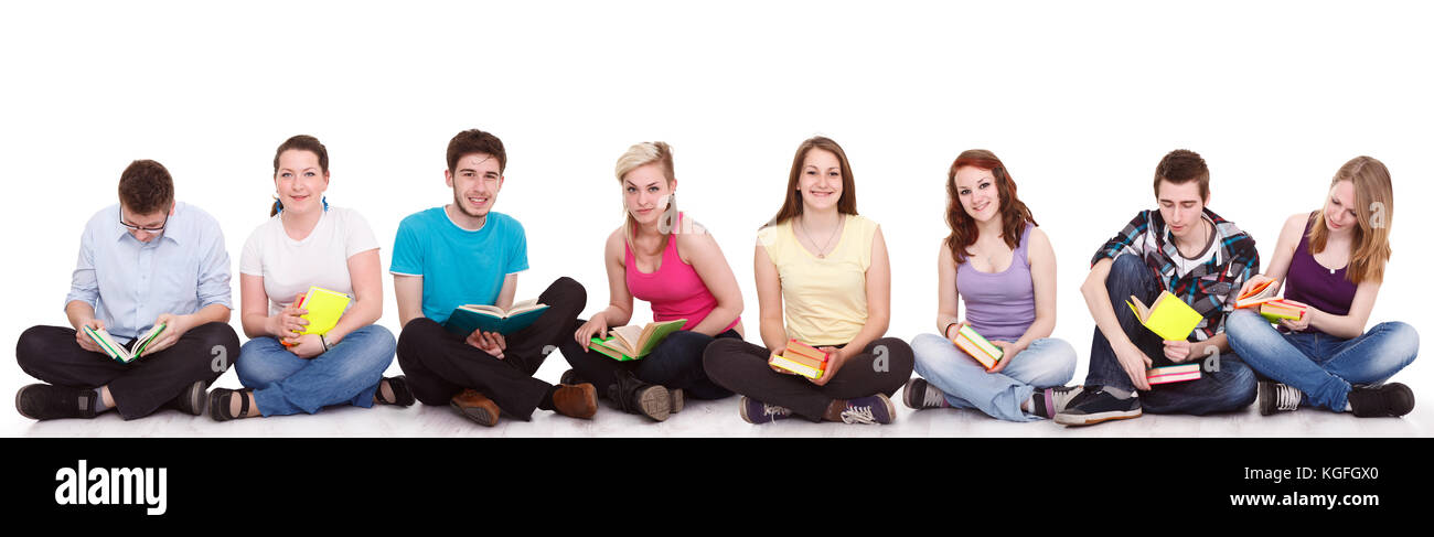 group of young students sitting on the floor with books, isolated on ...
