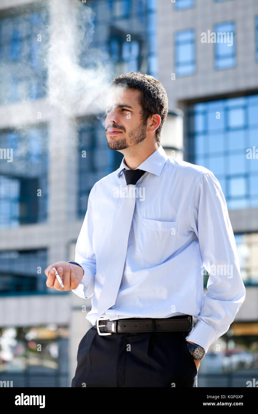 businessman smoking a cigar to relax Stock Photo - Alamy
